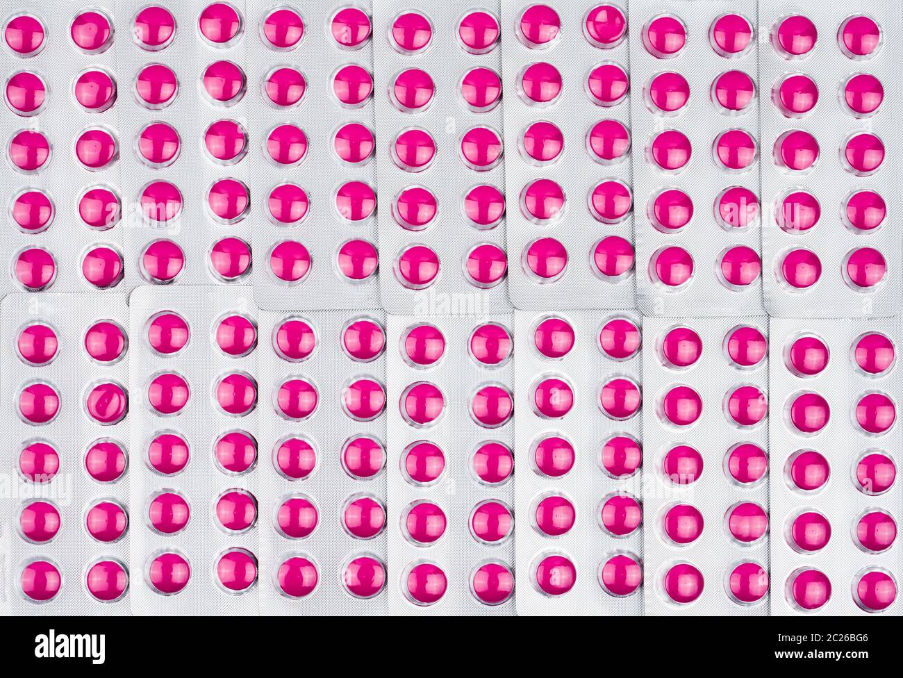 Full frame of round pink tablets pills in blister packs. Pink pills ...
