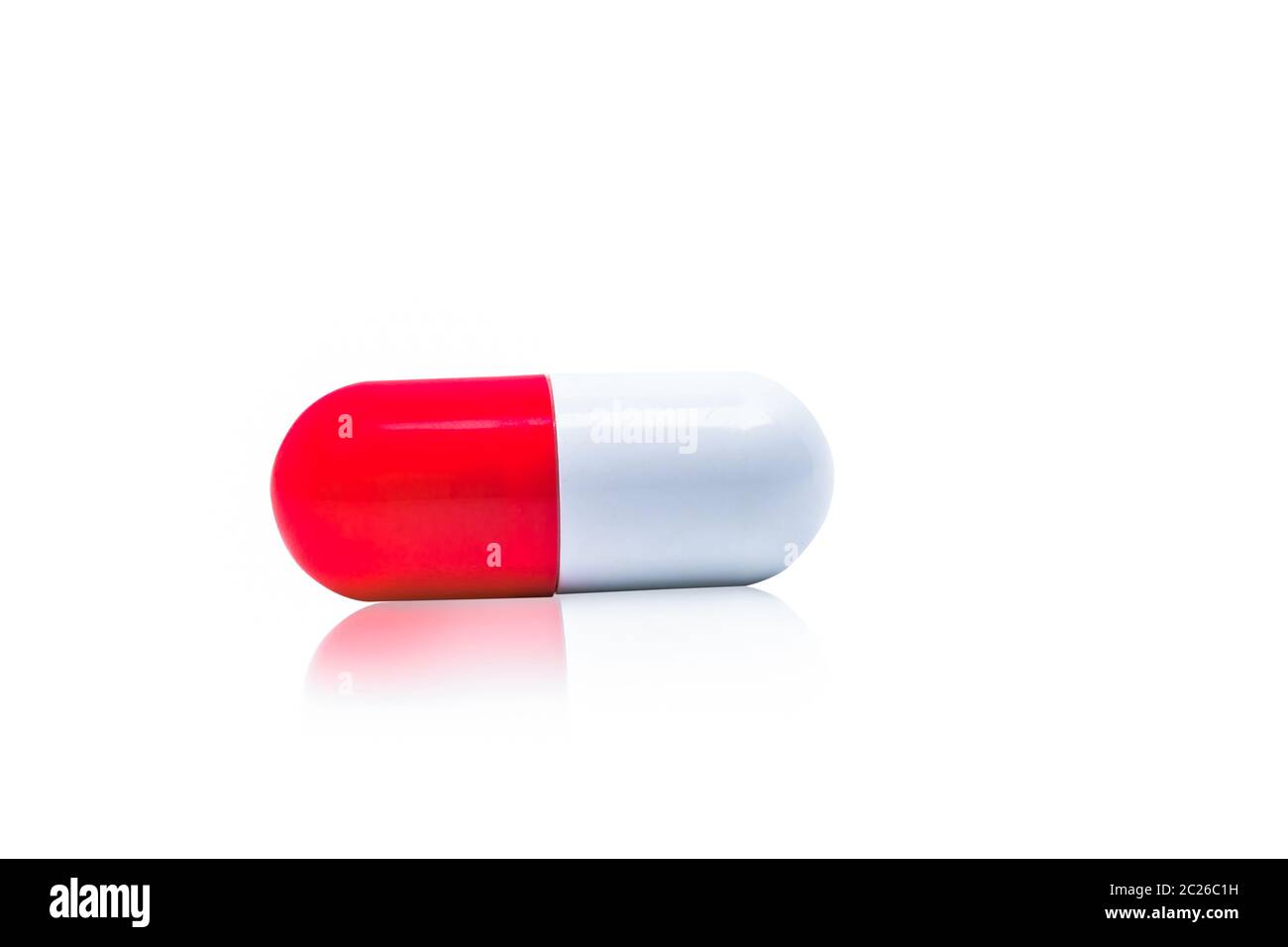 Red, white capsule pills isolated on white background with shadow and ...