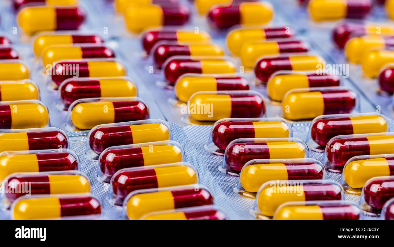 Red-yellow capsule pills in blister pack. Antibiotic capsule pills ...