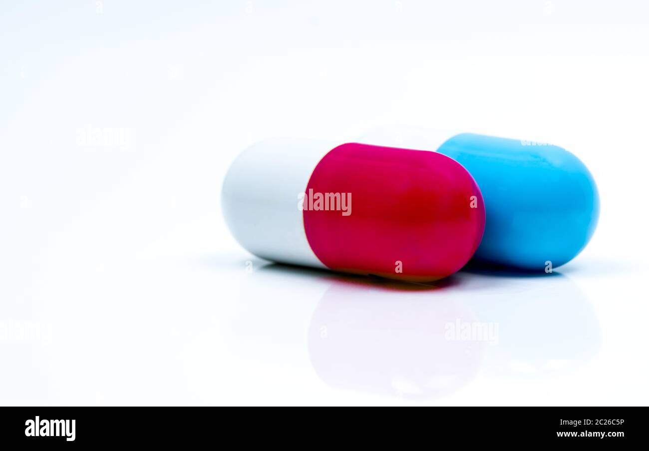 Two capsule pills isolated on white background. Global healthcare ...