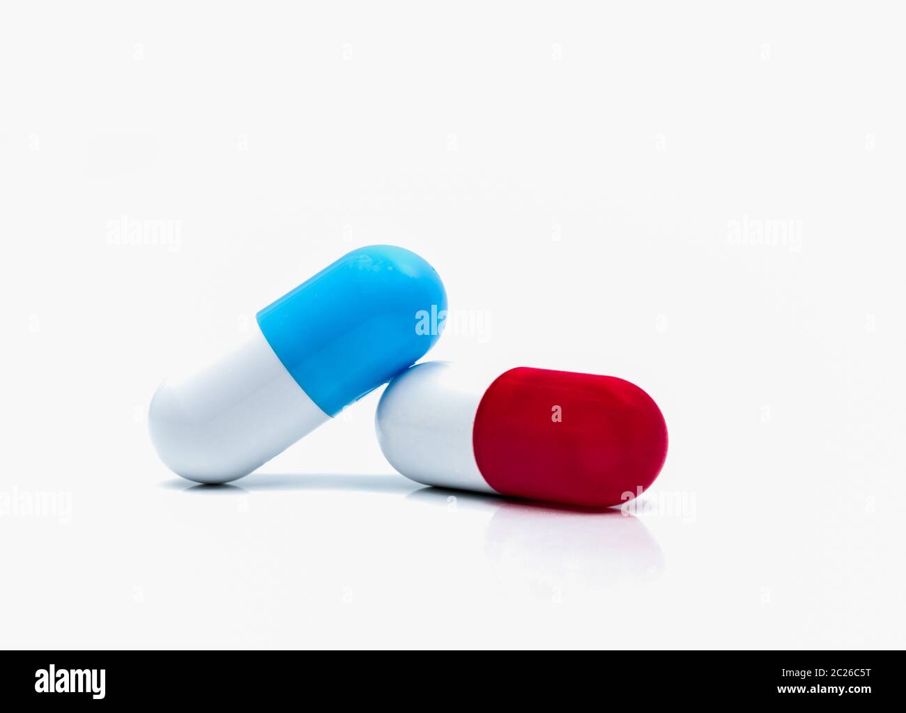 Two capsule pills isolated on white background. Global healthcare ...