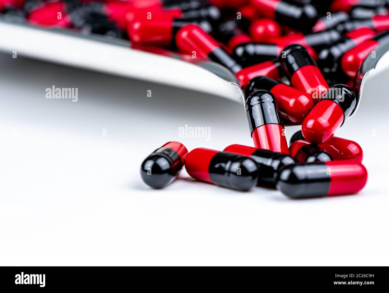 Selective focus of red and black capsule pills on stainless steel drug ...