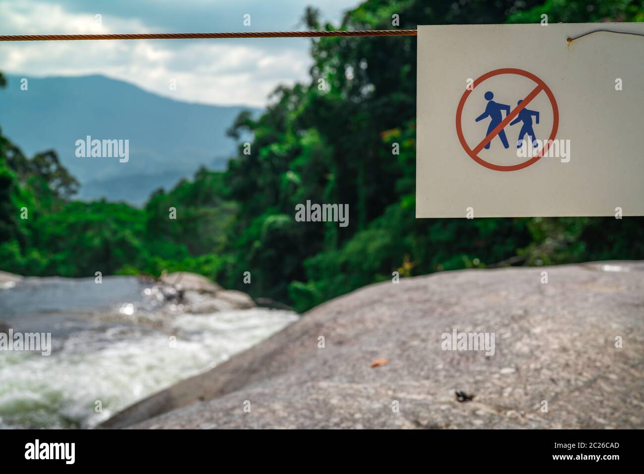 Do not walk of the trail. Warning sign in national park at waterfall in ...