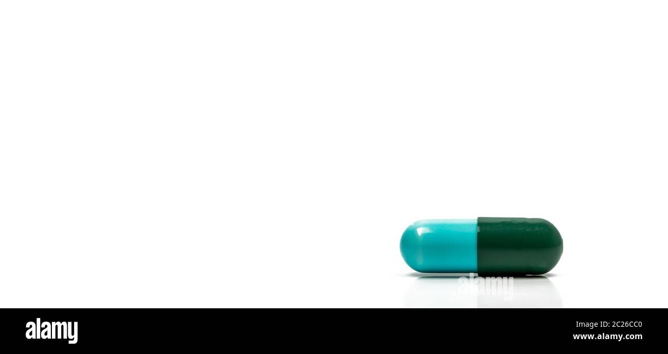 Blue, green antibiotics capsule pill isolated on white background with ...