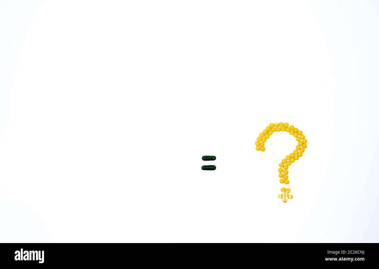 Questions mark made of yellow sugar coated tablet pills. Equal sign ...