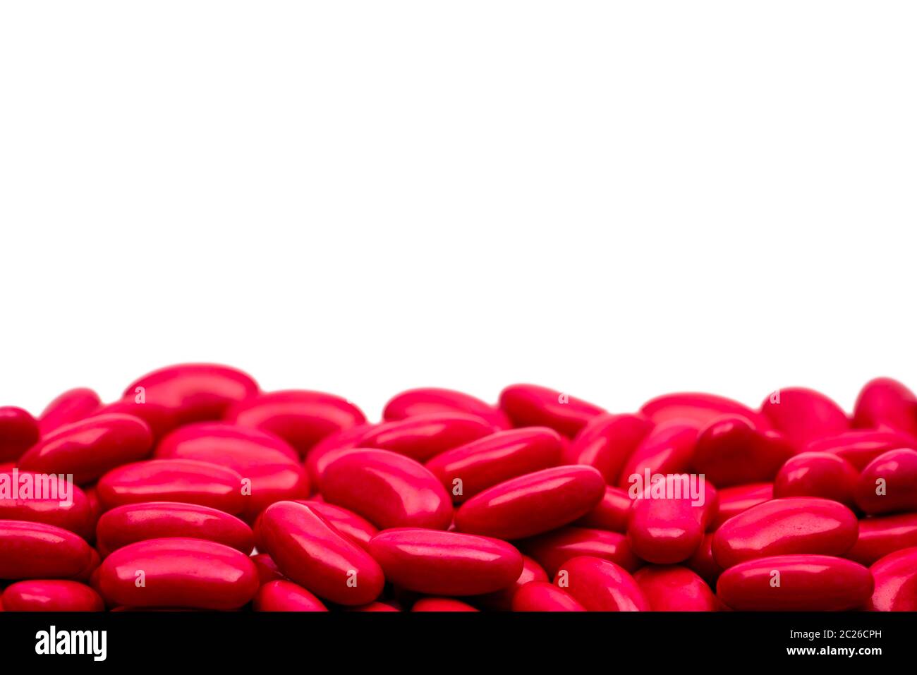 Macro shot detail of red kidney shape sugar coated tablet pills on ...