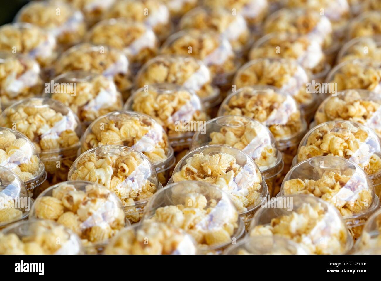 Popcorn in a plastic cup is beautifully placed. Unhealthy food or snack ...