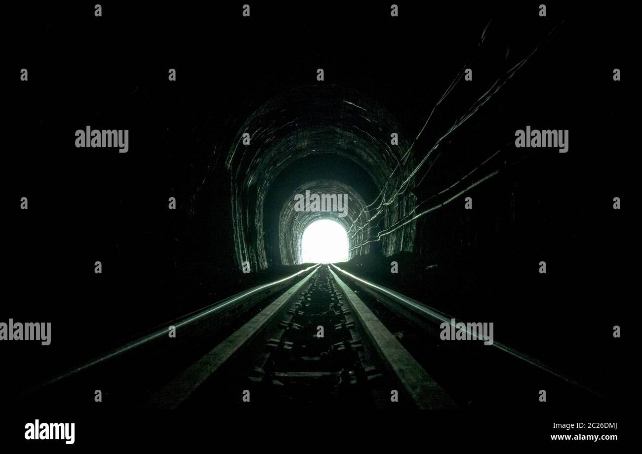 Train tunnel. Old railway in cave. Hope of life in the end of the way ...