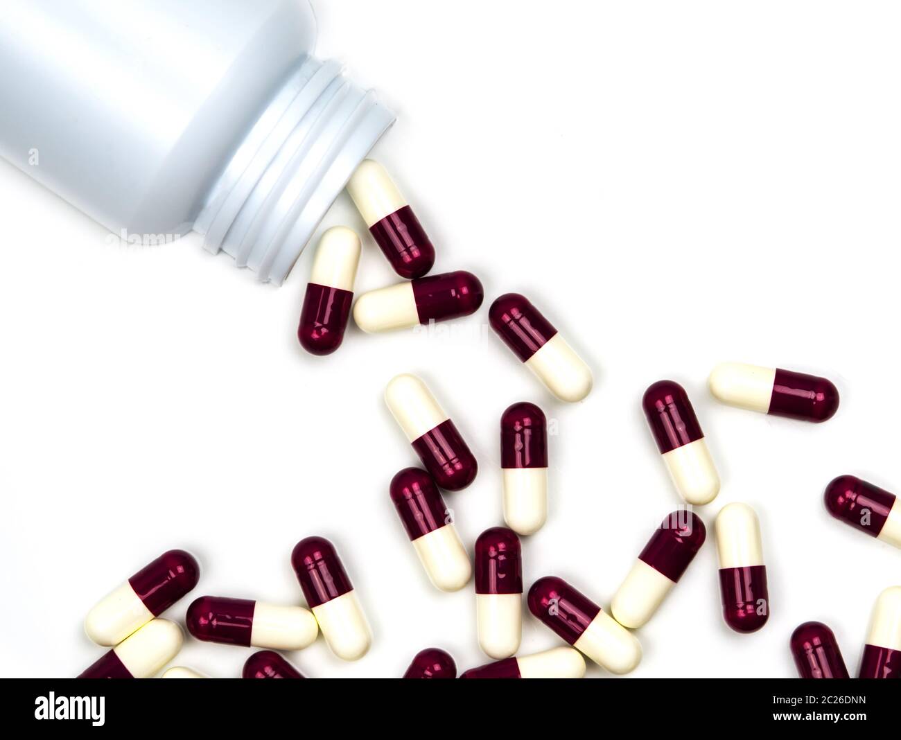 Antibiotic capsules pills spilling out of plastic bottle isolated on ...