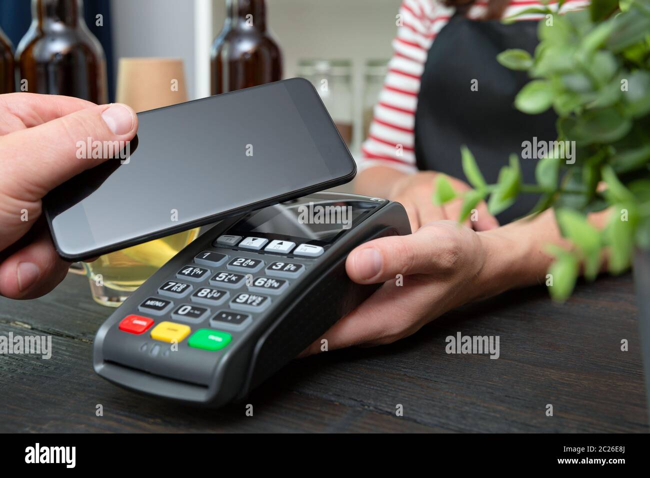 Customer making wireless or contactless payment using smartphone Stock ...