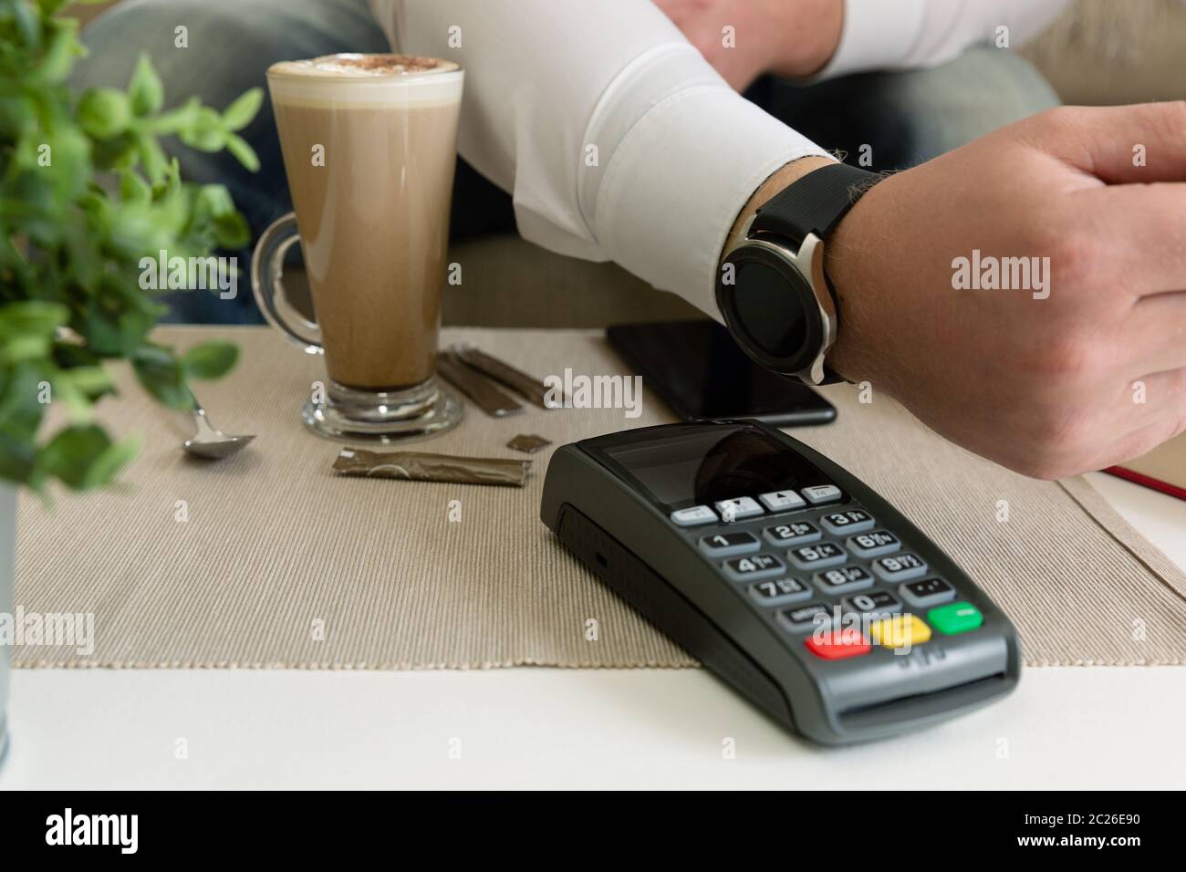 Customer making wireless or contactless payment using smartwatch, nfc ...