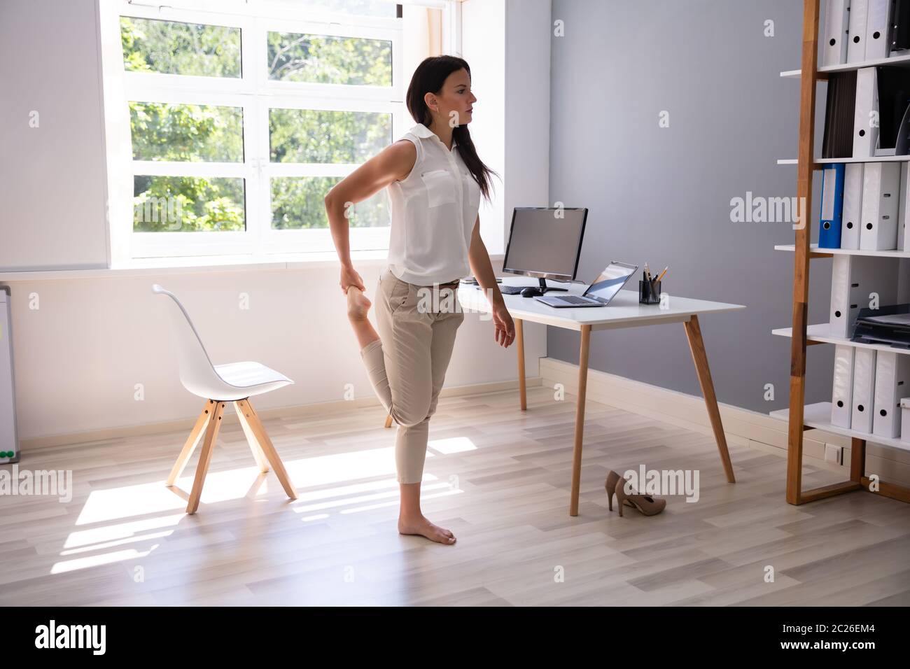 Woman one leg on desk hi-res stock photography and images - Alamy
