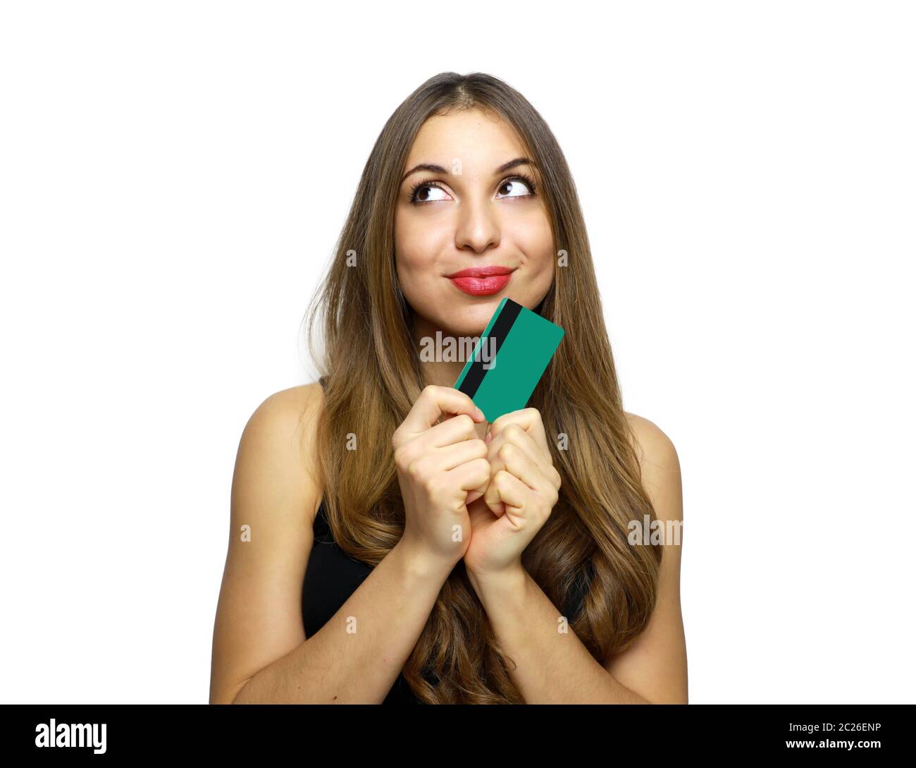 Pleased intrigued brunette woman in black dress holding credit card and ...
