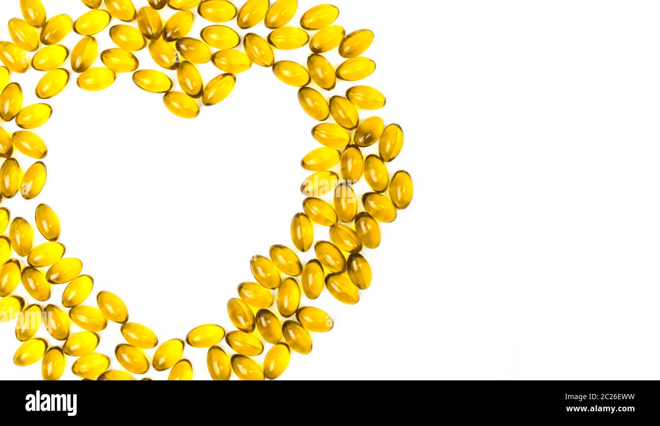 Heart shaped of cod liver oil isolated on white background with copy ...