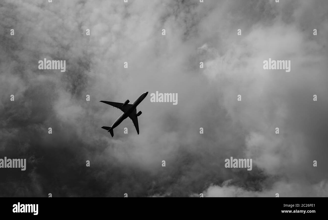 Commercial airplane on grey sky and clouds with copy space. Failed ...