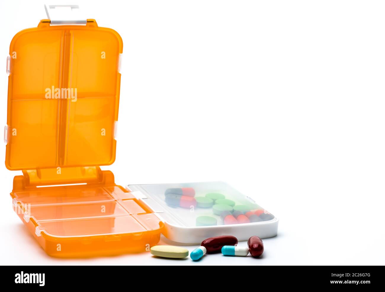 Orange pills box with tablets and capsule pills isolated on white ...