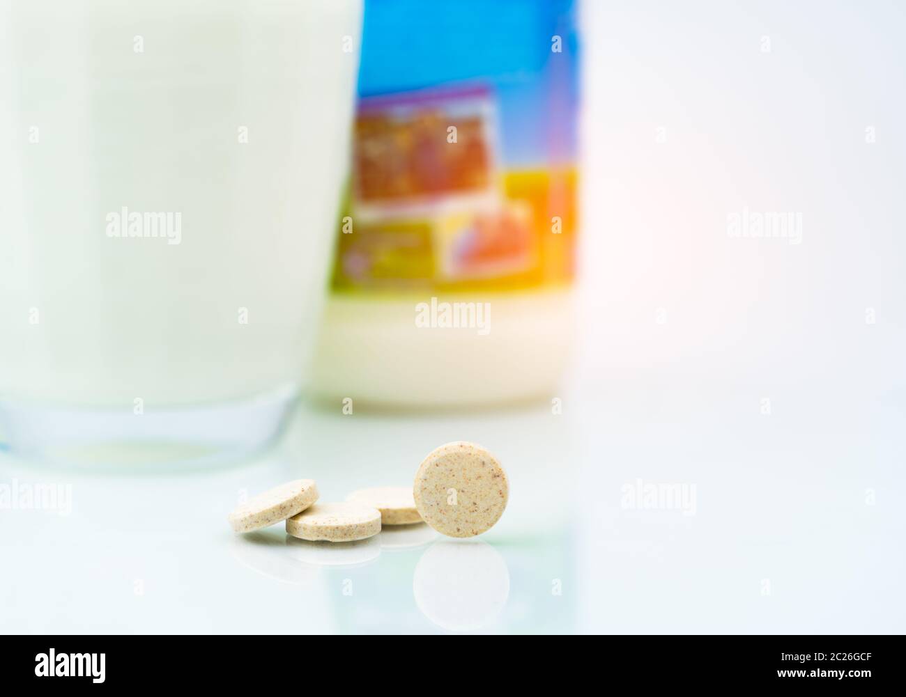 Sweetened flavored milk tablets and one glass of milk and milk bottle ...
