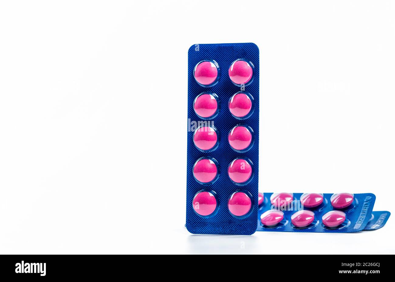 Ibuprofen in pink tablet pills pack in blue blister pack isolated on ...