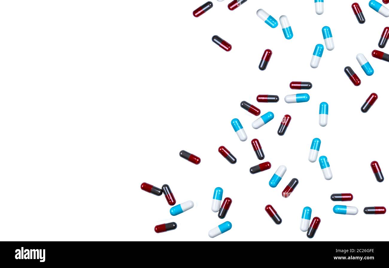 Red-gray and blue-white capsule pills spread isolated on white ...