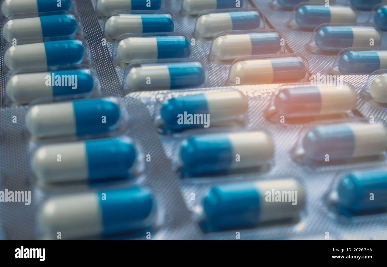 Blue and white capsules pill in blister pack arranged with beautiful ...