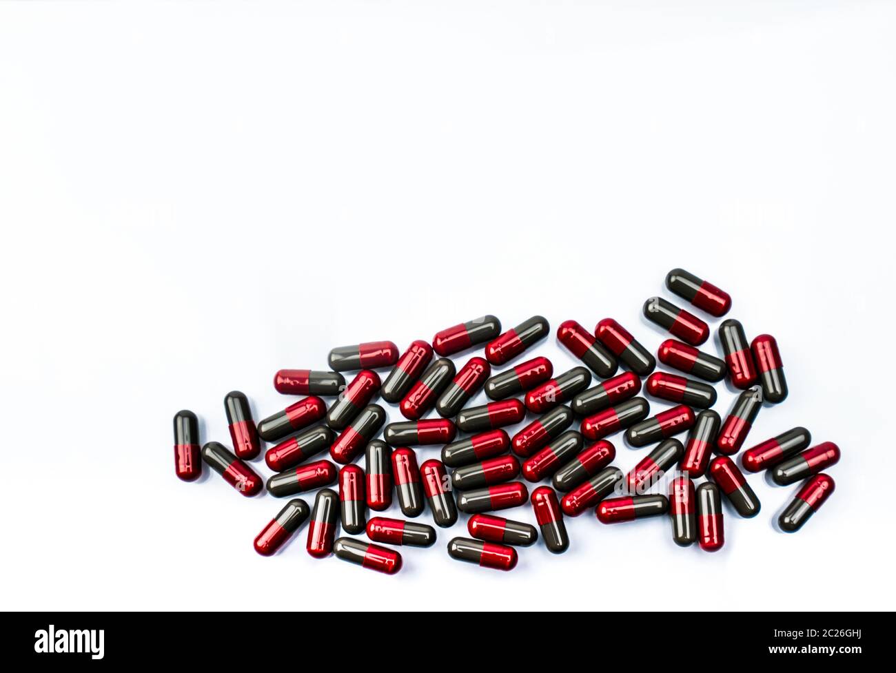 Top view pile of red and grey capsule pills isolated on white ...