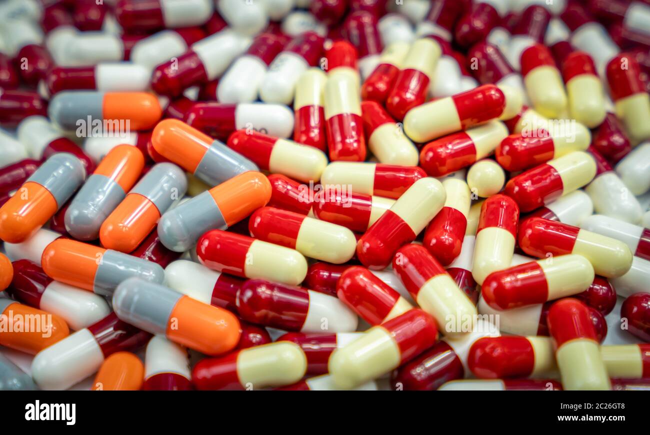 Pile of antibiotic capsule pills. Pharmaceutical industry. Drug ...