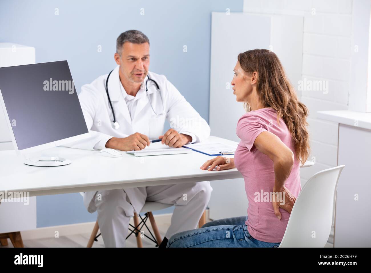 Doctor talking patient physical pain hi-res stock photography and ...