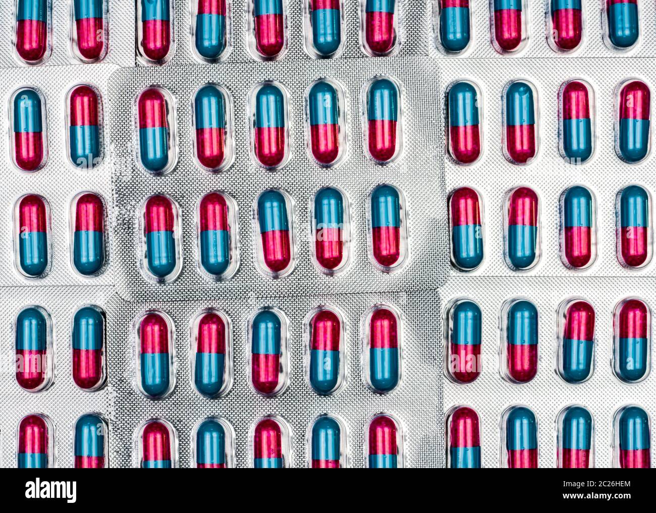 Colorful of blue, pink capsule with granule in side pills. Pills in ...