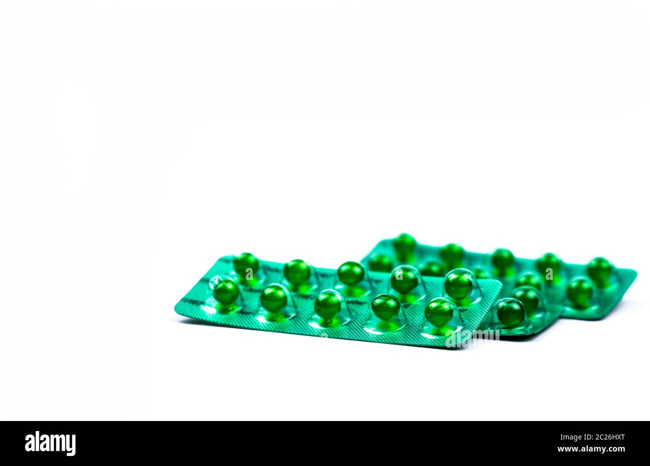 Green round soft capsule pills isolated on white background with copy ...