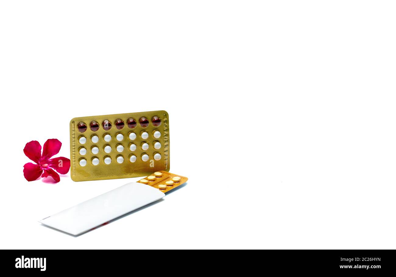 Contraceptive pills or birth control pills with pink flower on white ...