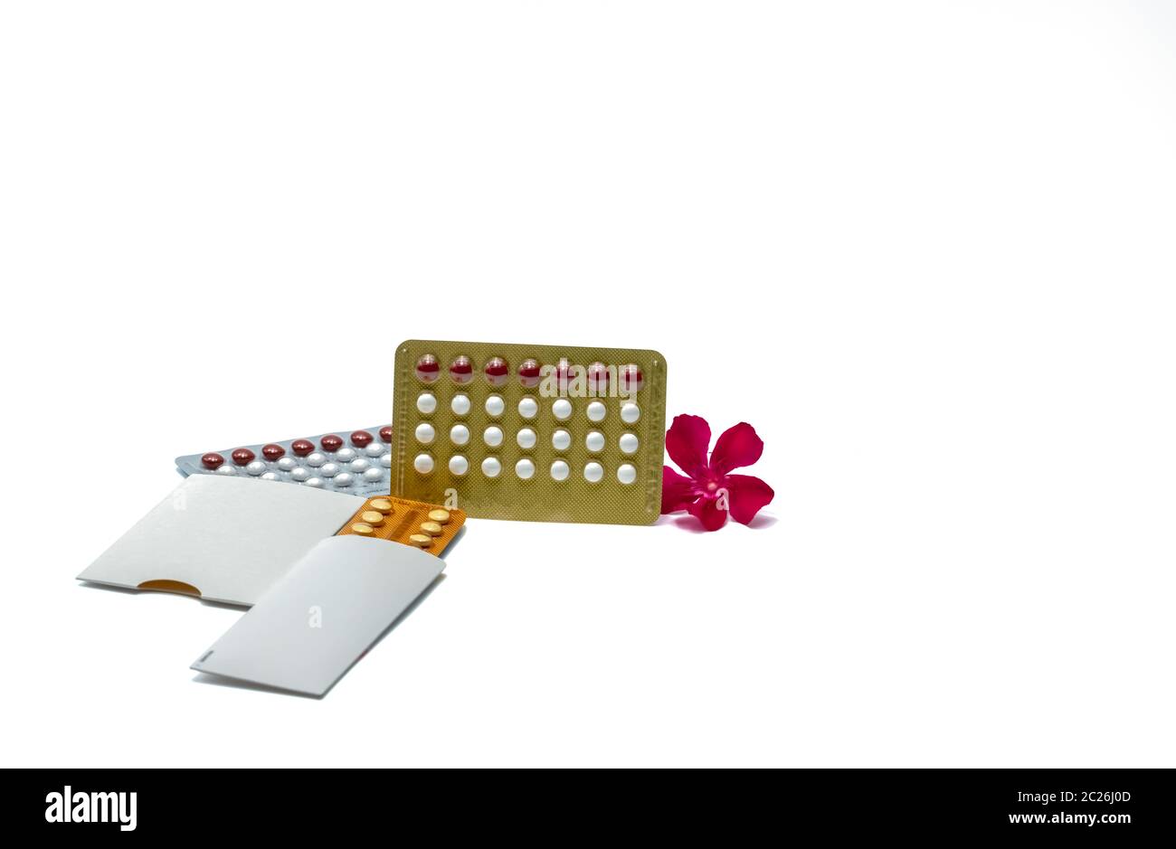 Contraceptive pills or birth control pills with pink flower on white ...