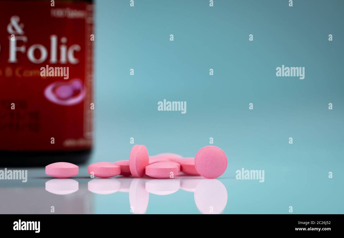 Round pink tablets pill on gradient background. Vitamins and minerals ...