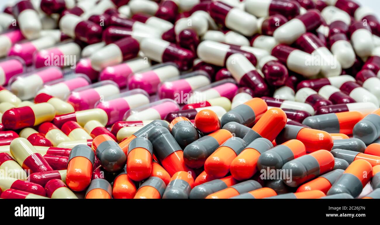 Pile of antibiotic capsule pills. Pharmaceutical industry. Drug ...