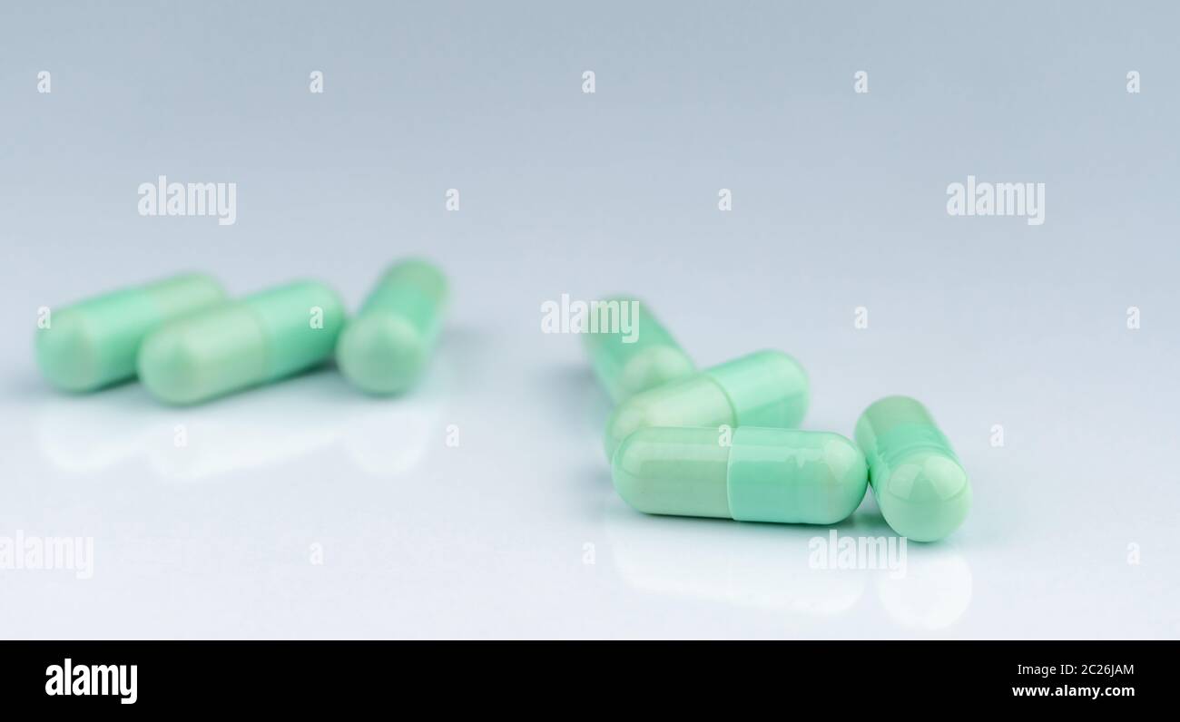 Selective focus on green capsule pill of herbal medicine ...