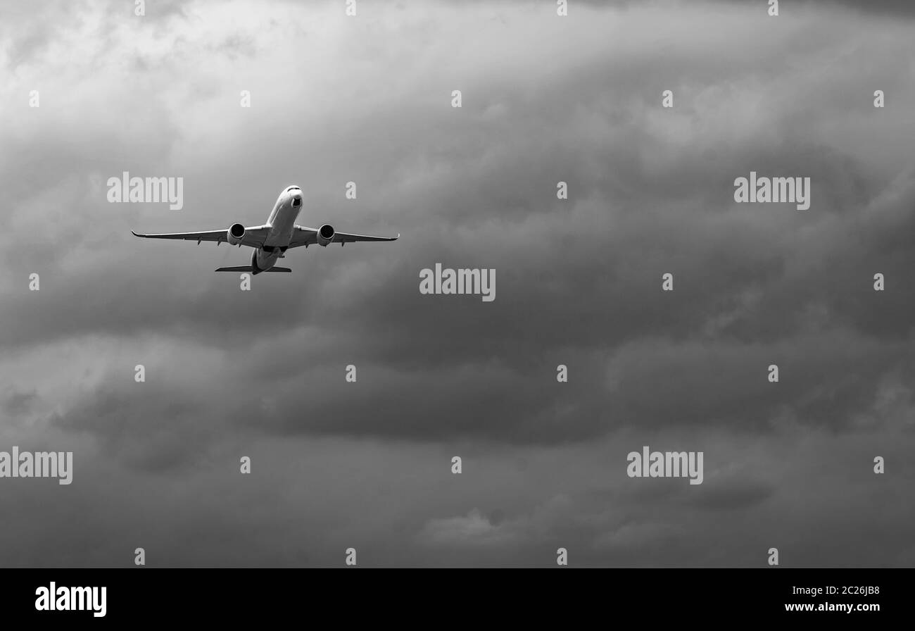 Commercial airplane on grey sky and clouds with copy space. Failed ...