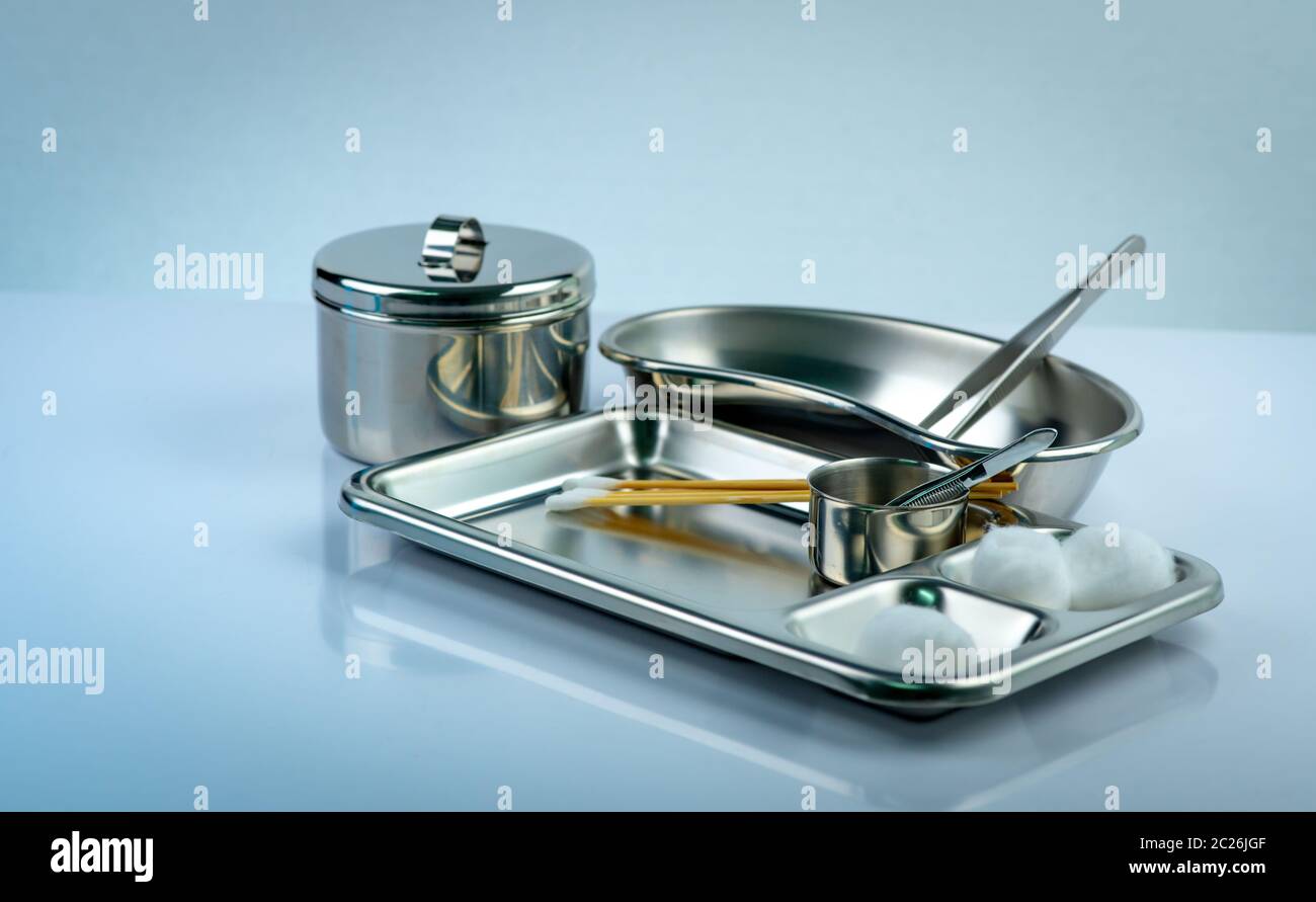 Wound care dressing set on stainless steel plate. White cotton ball ...
