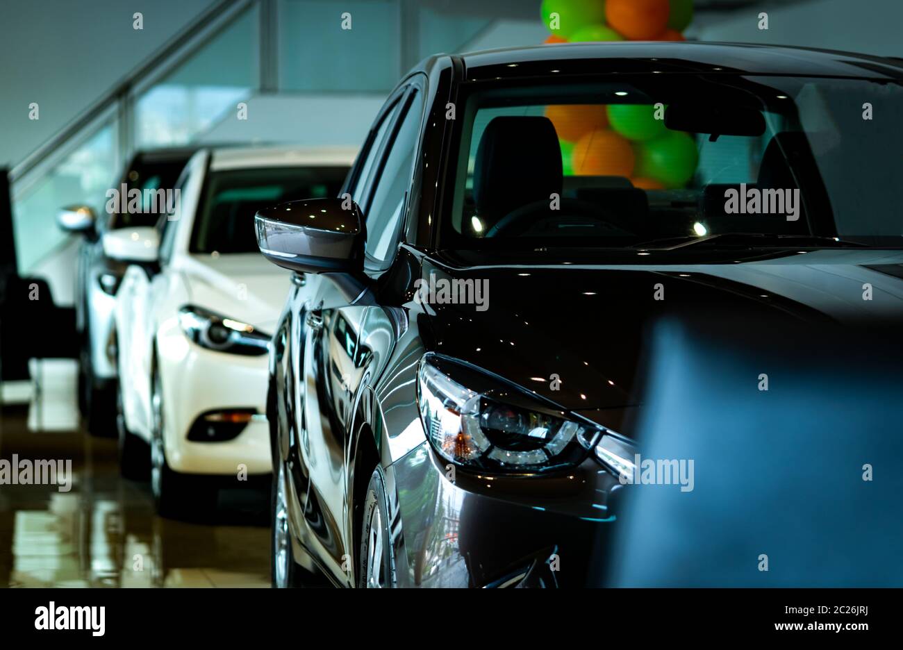 New luxury shiny compact car parked in modern showroom. Car dealership ...