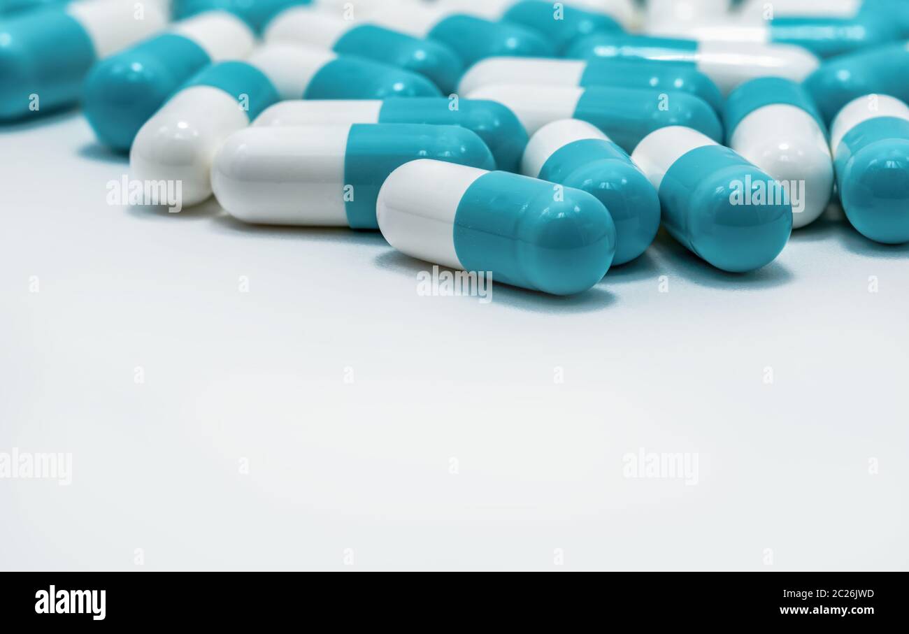 Blue and white capsule pills on white background. Antibiotics drug ...