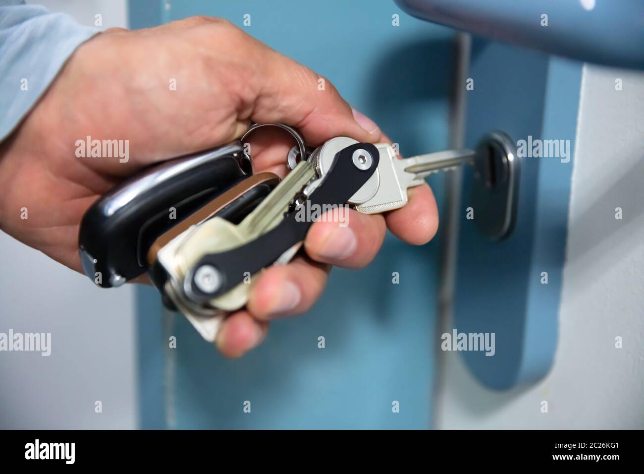 Man Using Key Organizer To Open Door Stock Photo - Alamy