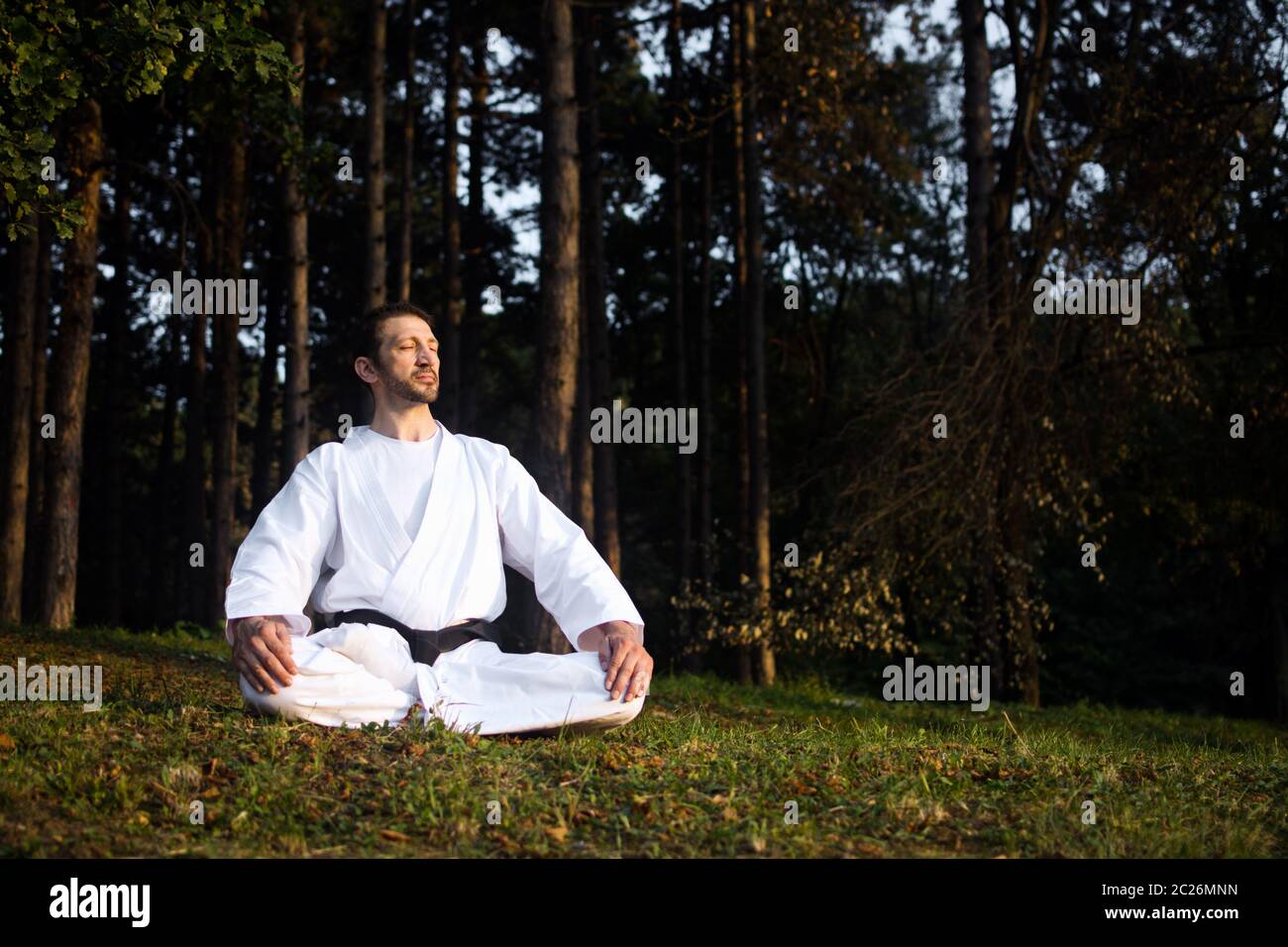 Man in white kimono meditating hi-res stock photography and images - Alamy