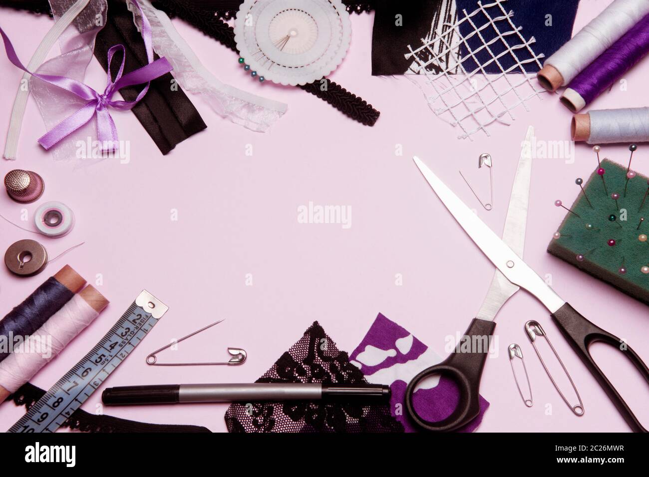 Sewing kit or sewing supplies are on pink background Stock Photo - Alamy