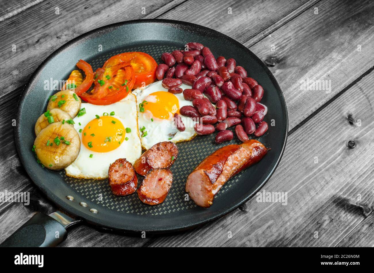 English breakfast on frying pan and wood table Stock Photo - Alamy