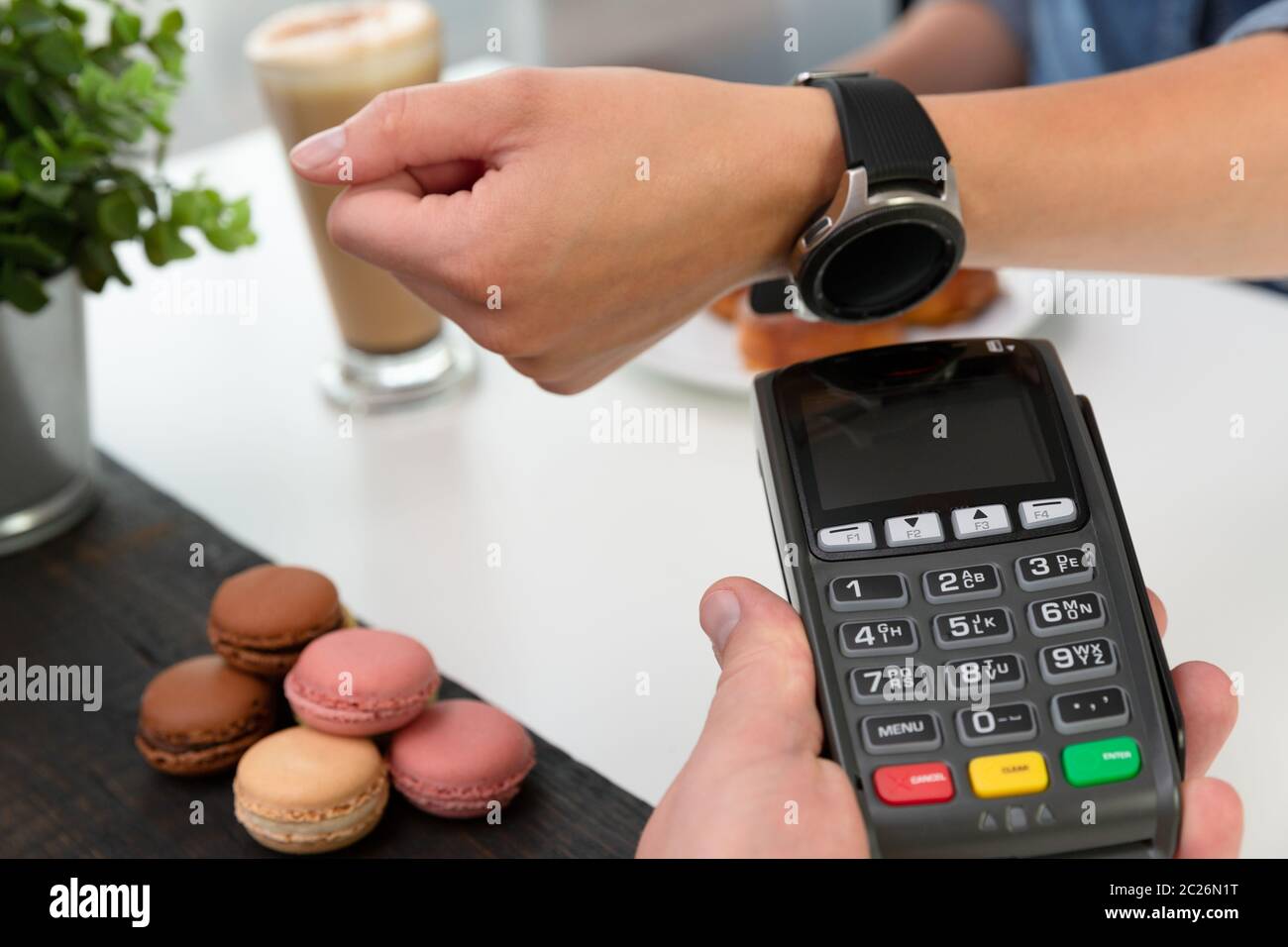Customer making wireless or contactless payment using smartwatch, nfc ...