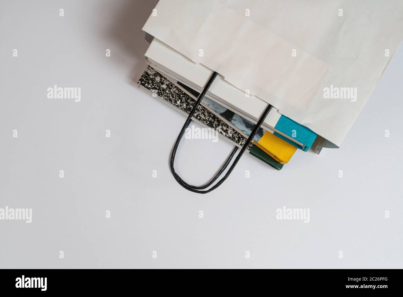 some books inside a white paper bag on the table Stock Photo - Alamy