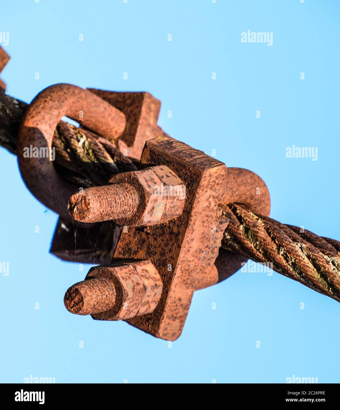 Fastening clamp on the steel cable of the bridge. Connecting elements ...
