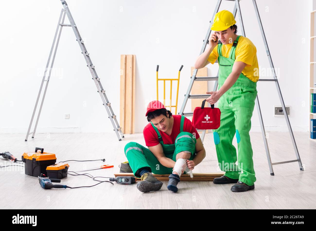 Injured worker and his workmate Stock Photo - Alamy