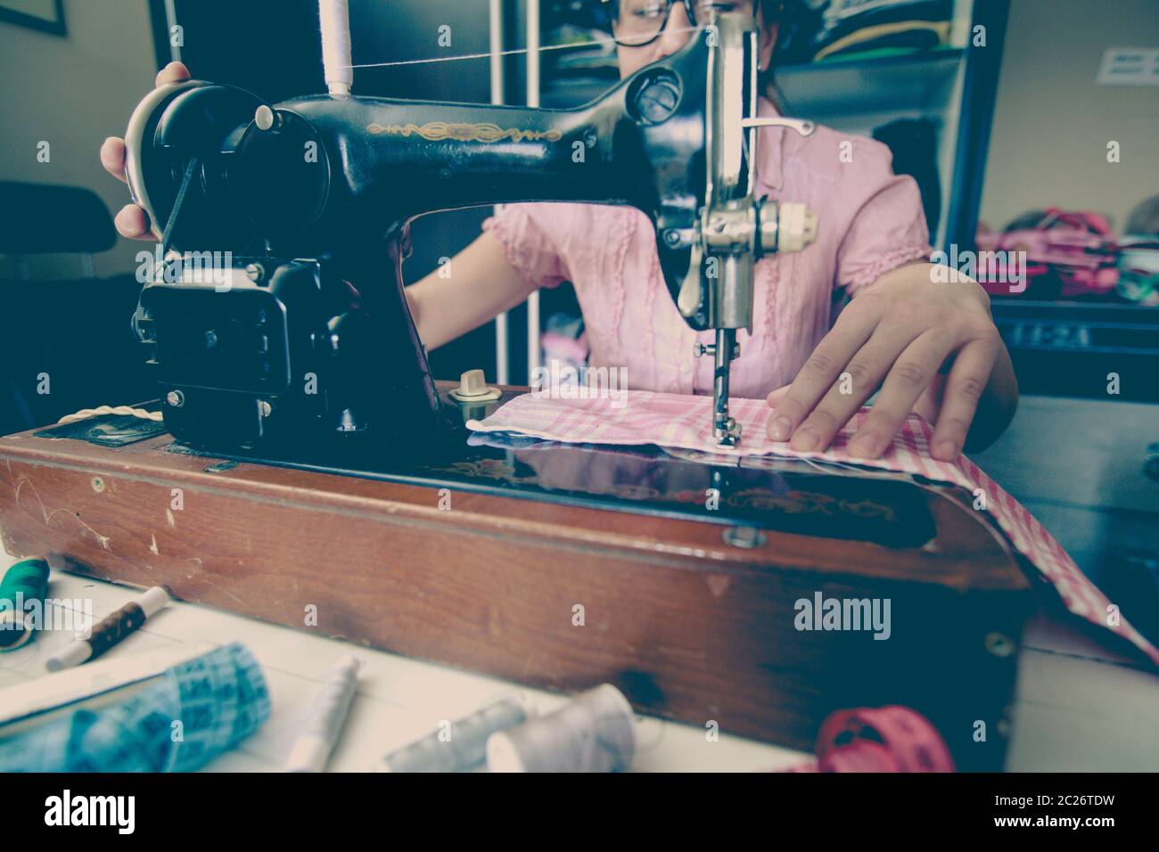 Woman tailor working with old sewing machine at home. Vintage edited ...