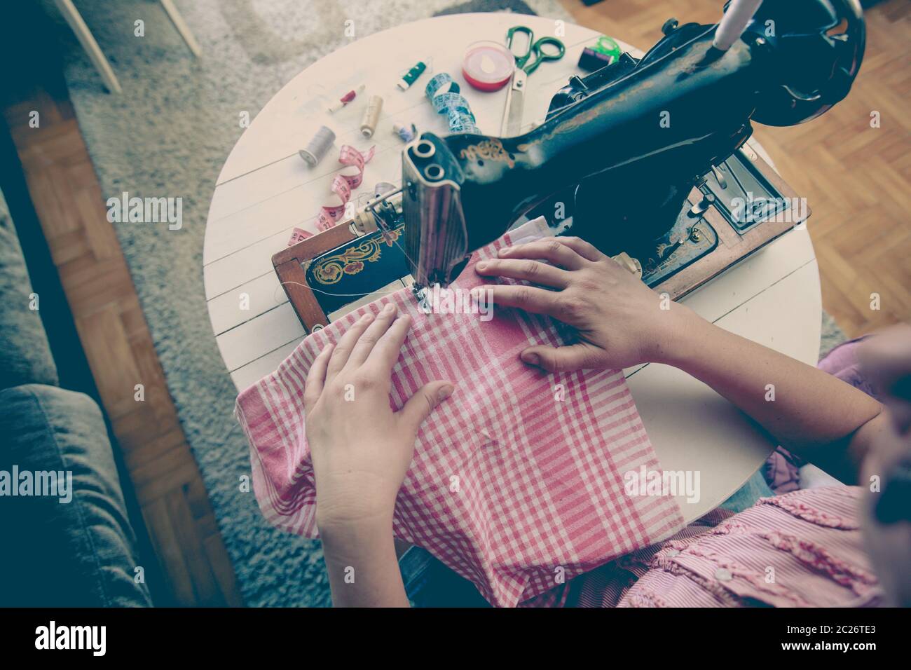 Top view of woman tailor working with old vintage sewing machine at ...