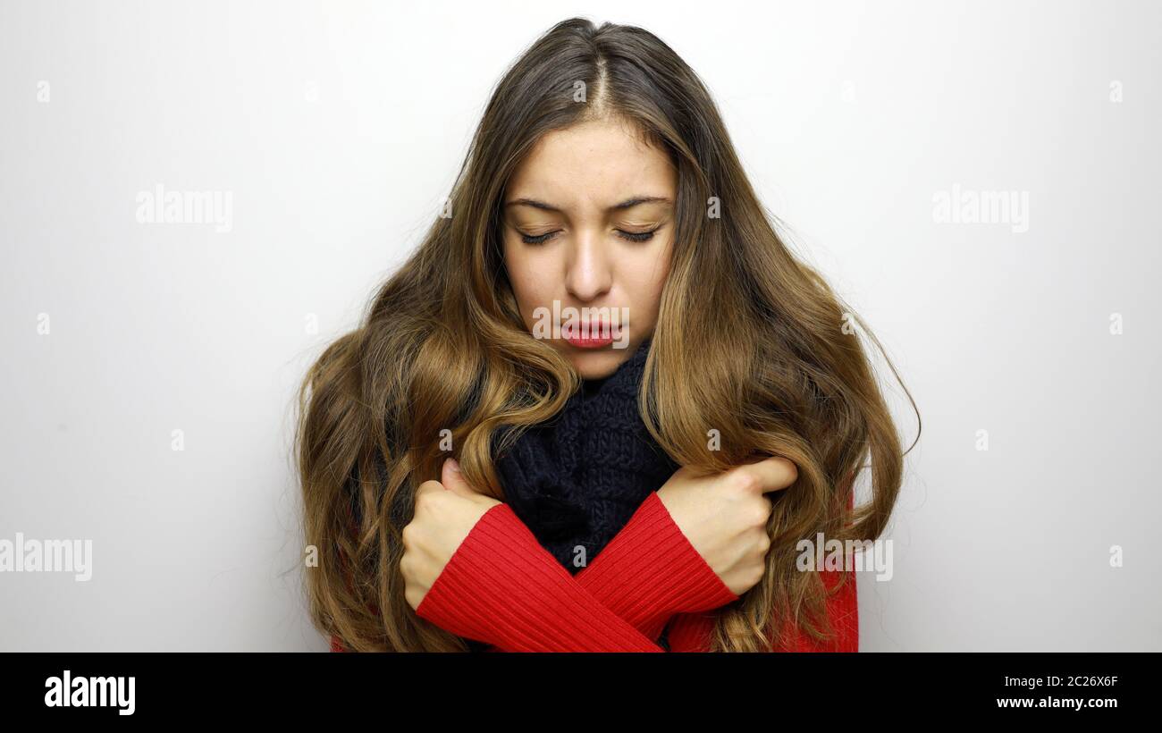 Portrait of a freezing woman in winter cloth standing isolated on a ...