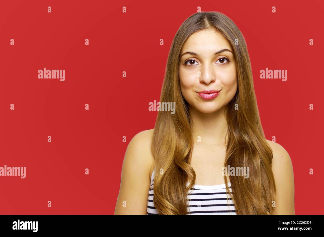Close up portrait of charming young woman with gently smile posing over ...